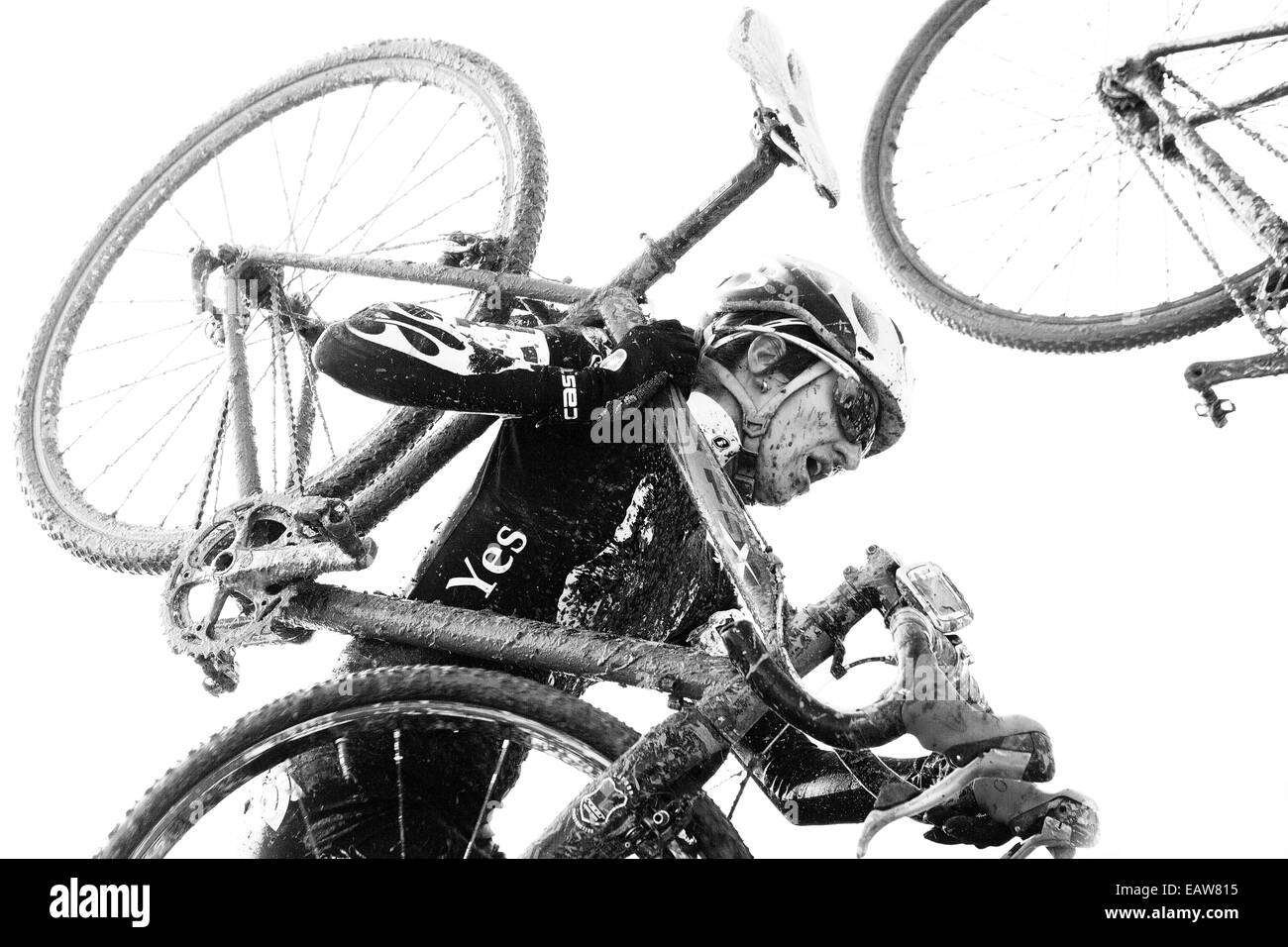 A woman carries her bicycle up a flight of stairs during a Cyclocross ...