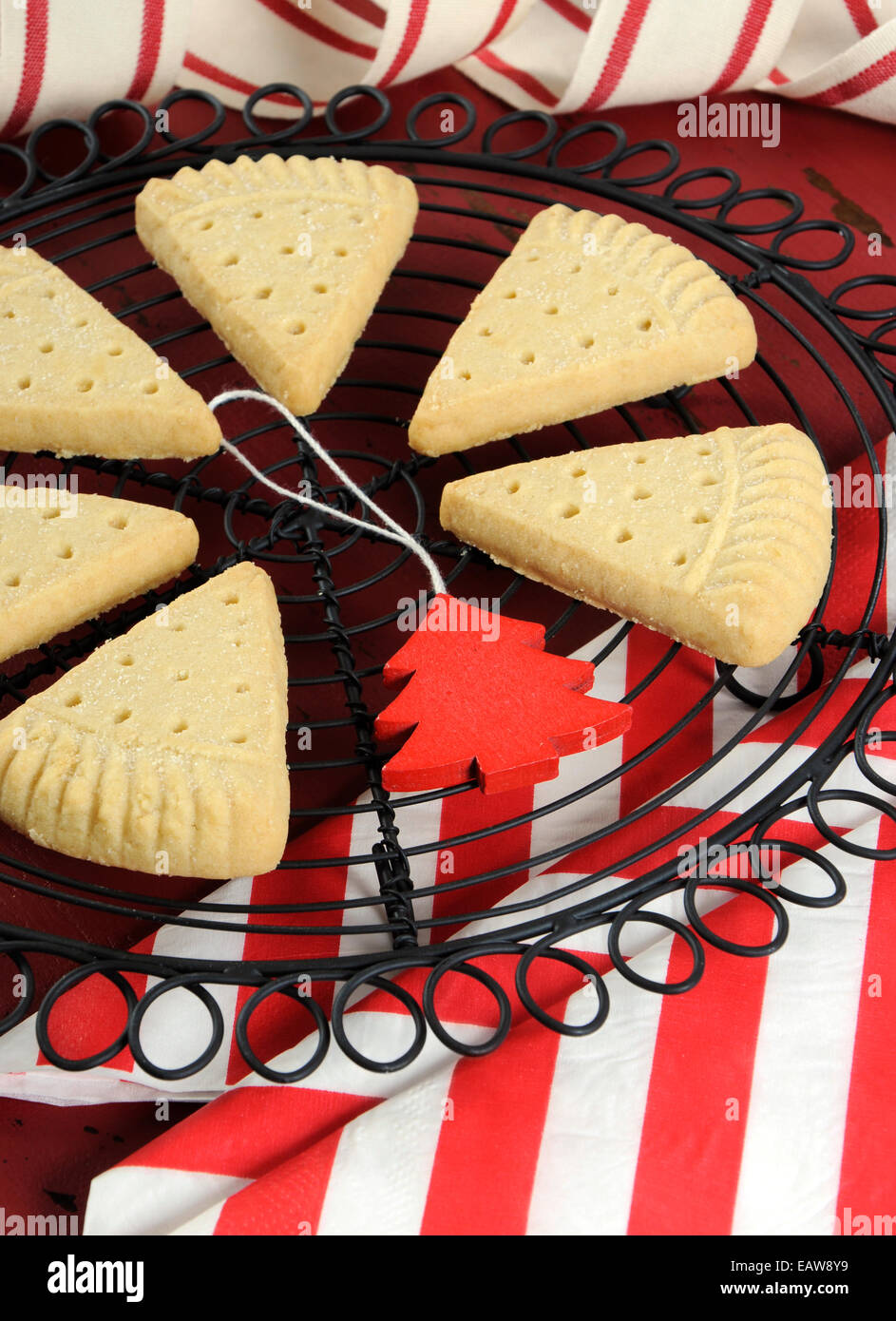 Christmas shortbread triangle cookies on vintage baking rack on dark ...
