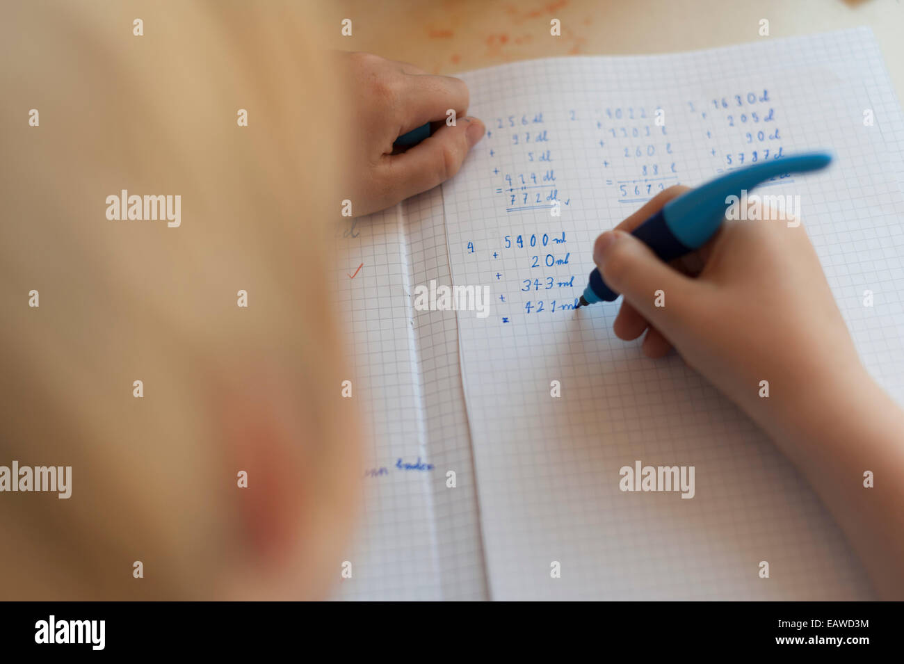 a 10-year old schoolchild is doing his math homework Stock Photo - Alamy