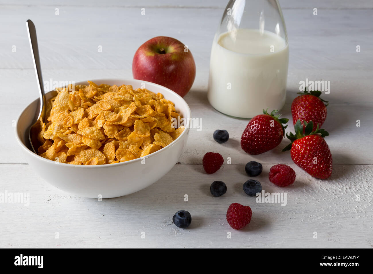 Cornflakes in a bowl with milk and fruits Stock Photo - Alamy