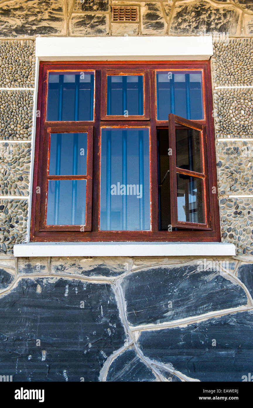 Prison bars visible through timber and glass window shutters Stock ...
