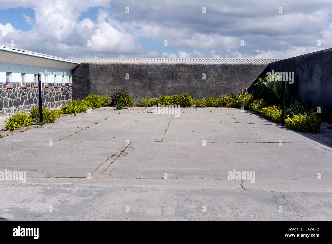 A barren concrete exercise yard surrounded by prison cells Stock Photo ...