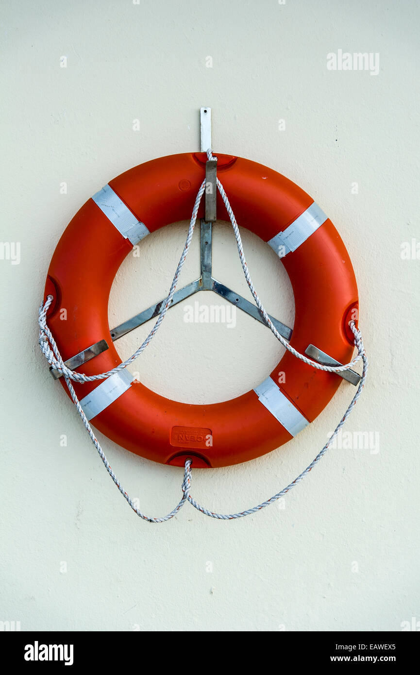 An orange rescue ring hangs on the wall at an ocean ferry terminal ...