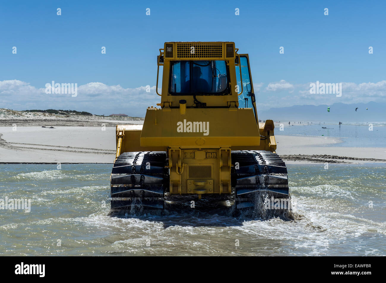 Bulldozers move beach sand to prevent sand dune erosion by the ocean ...