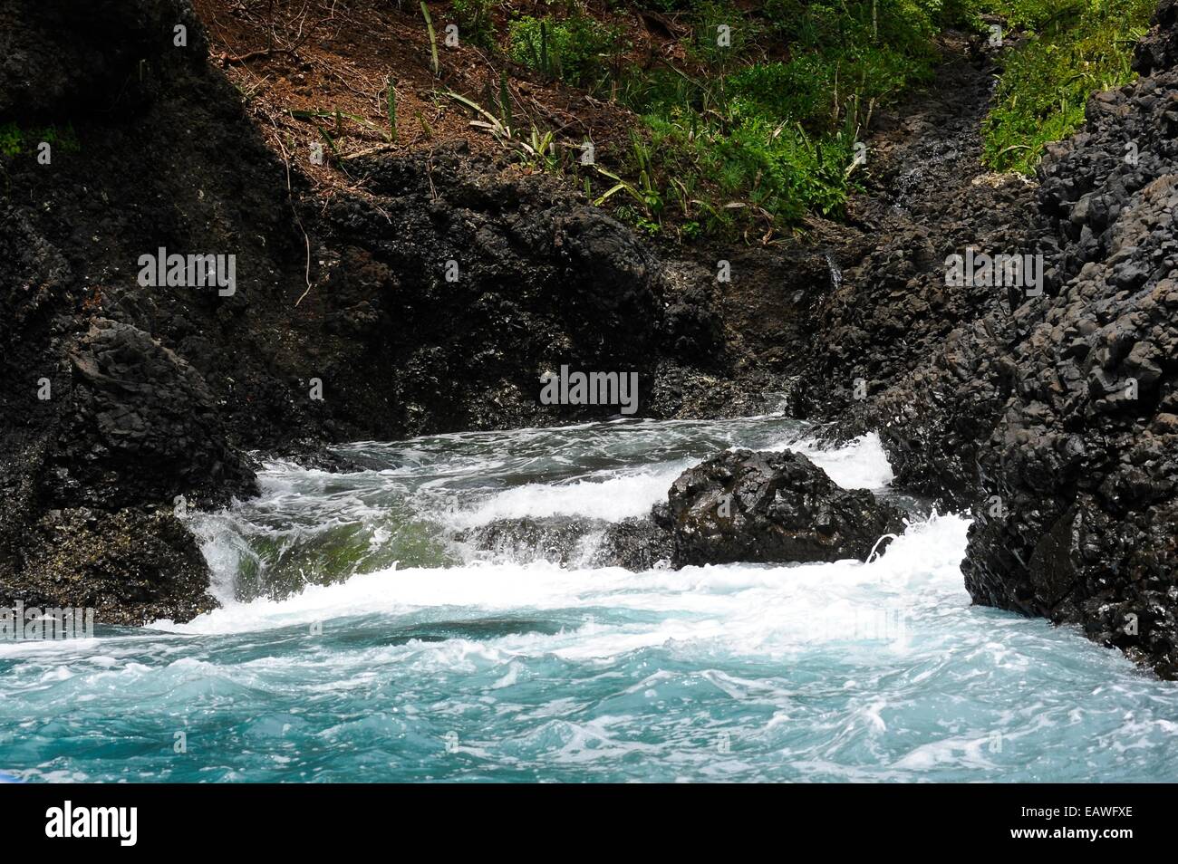 Clear blue water flows over a rocky stream bed Stock Photo - Alamy