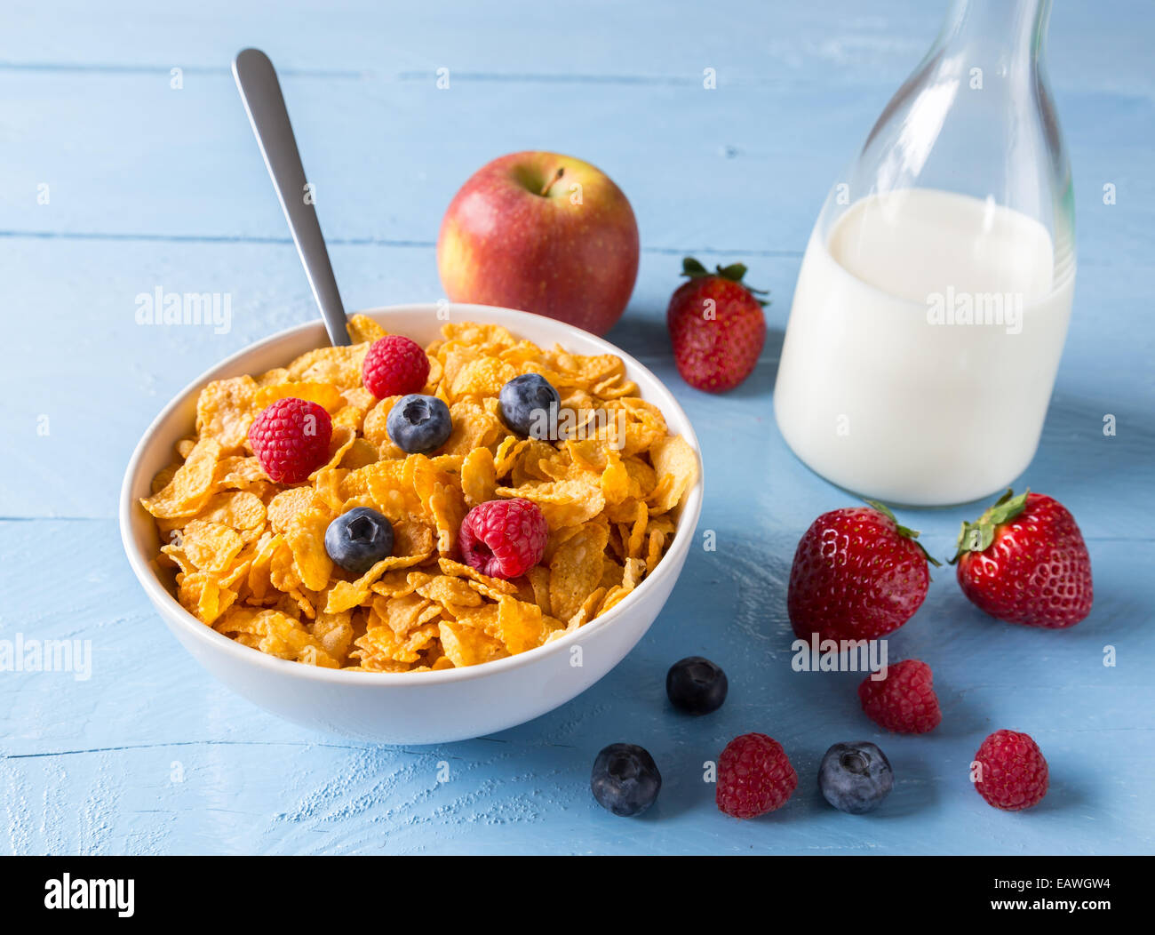Cornflakes in a bowl with milk and fruits Stock Photo - Alamy