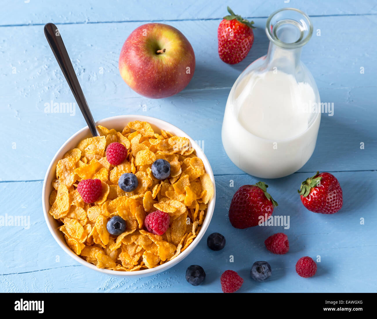 Cornflakes in a bowl with milk and fruits Stock Photo - Alamy