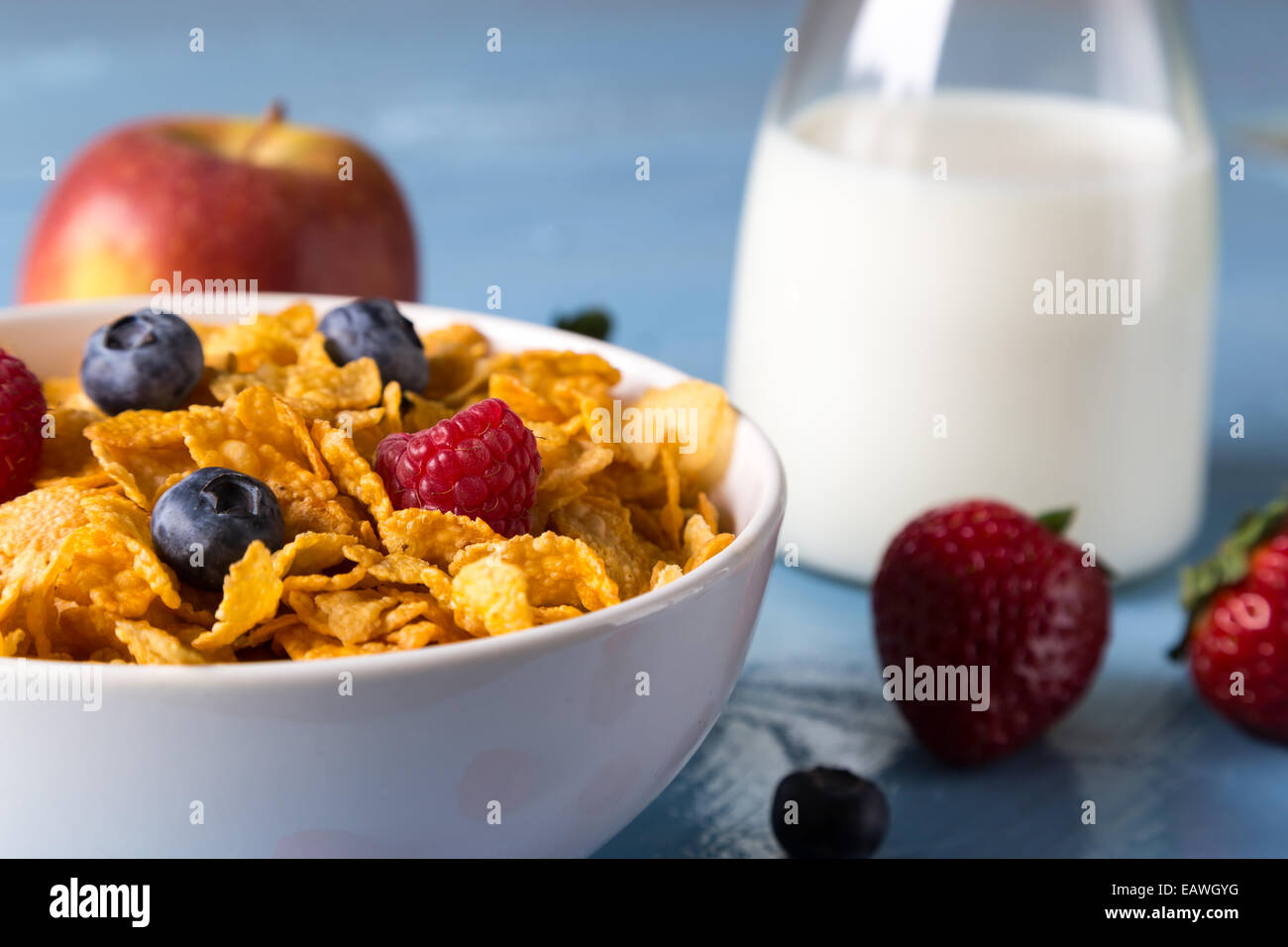 Cornflakes in a bowl with milk and fruits Stock Photo - Alamy