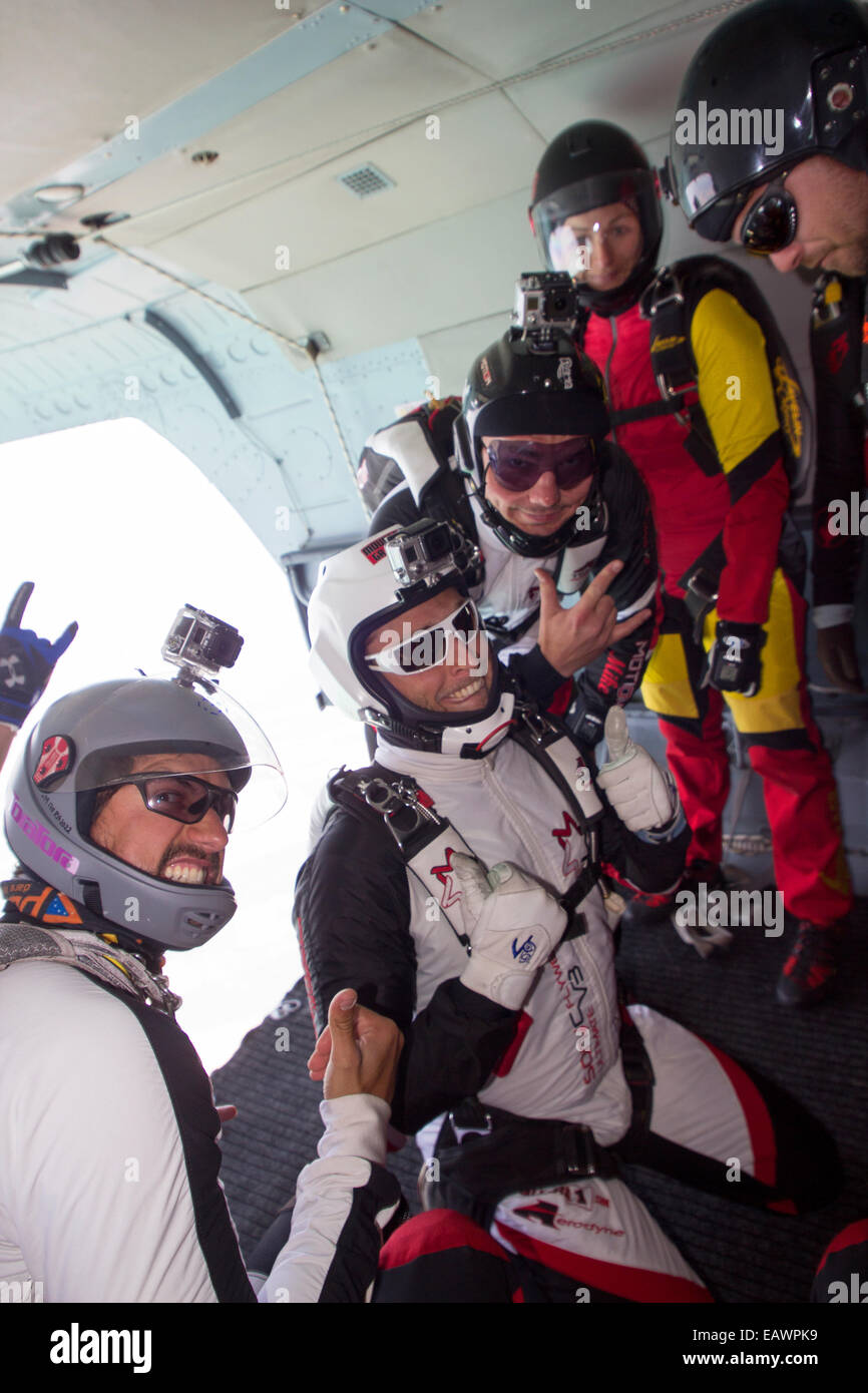 Skydivers are preparing inside the aircraft for a tandem jump into the ...