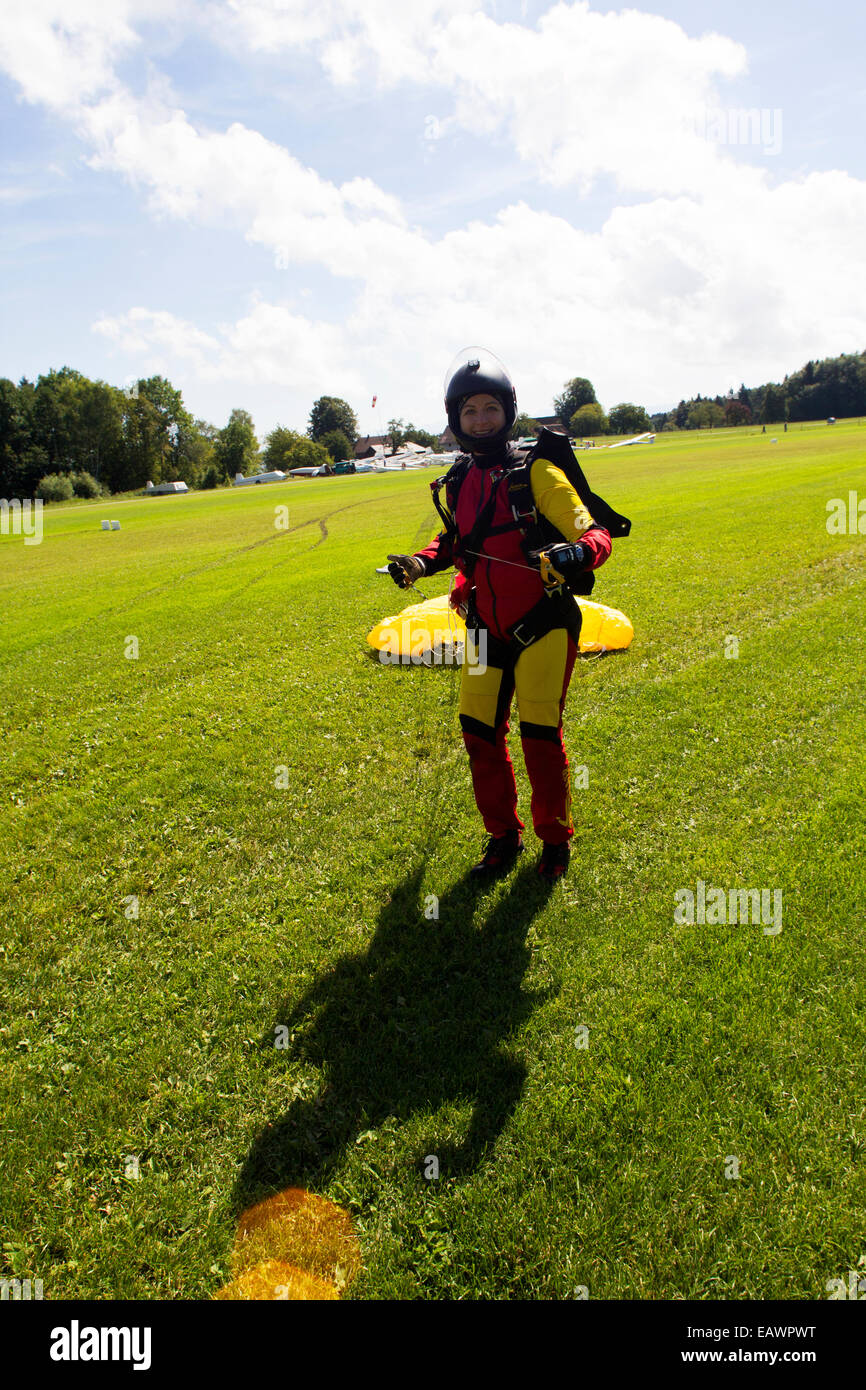 This skydiver girl landed with her parachute and is now very happy to ...