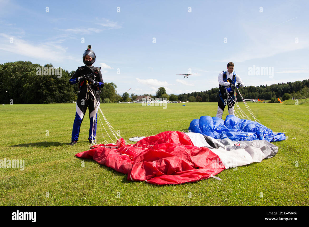 These two skydivers landed with their parachute and now very happy to ...