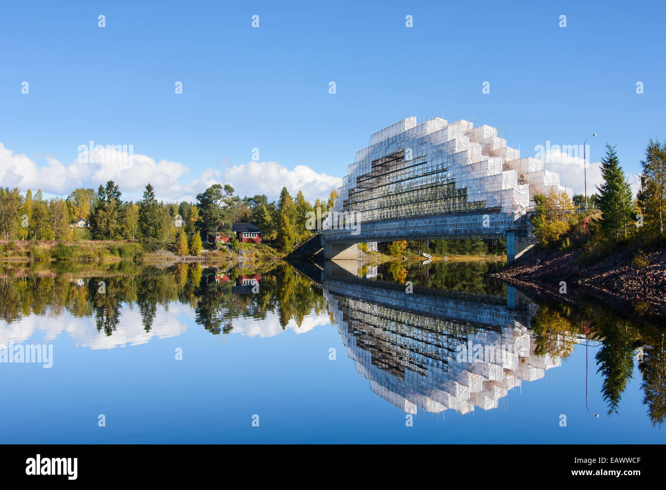 Unique bridge under construction over a still lake Stock Photo - Alamy