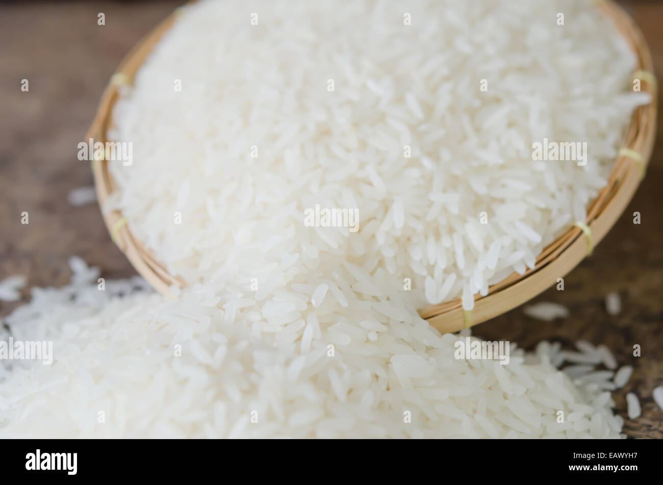white rice grains on wooden table Stock Photo - Alamy