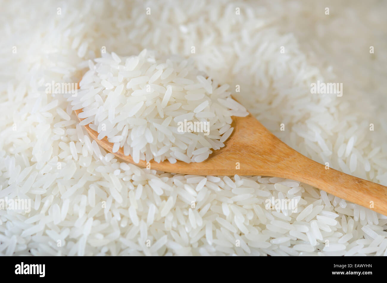 Wooden spoon with rice lying against the background rice Stock Photo ...