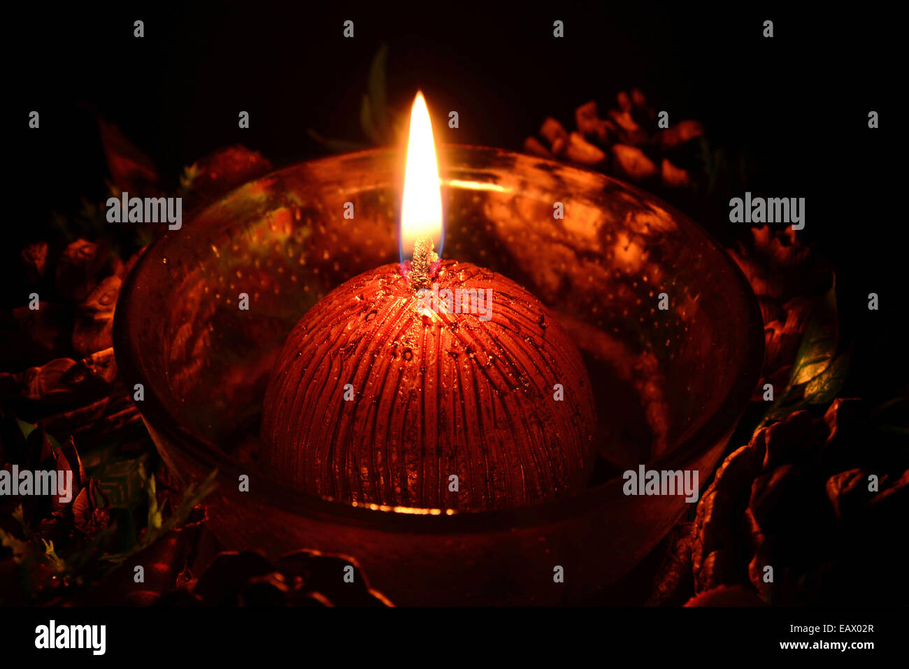 Red christmas candle burning on a black background Stock Photo - Alamy