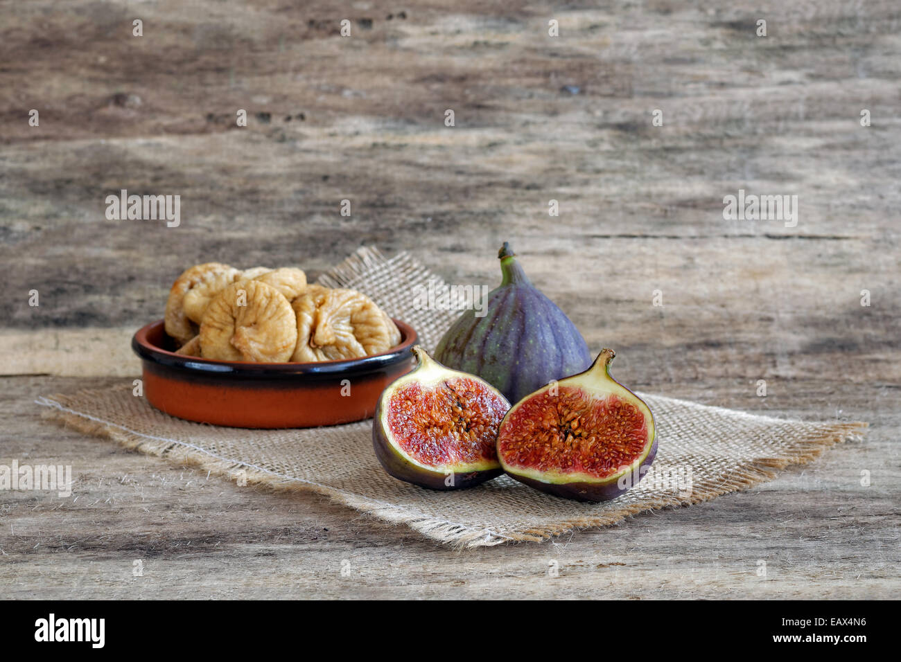 Fresh cut and dried figs on wood and burlap Stock Photo - Alamy