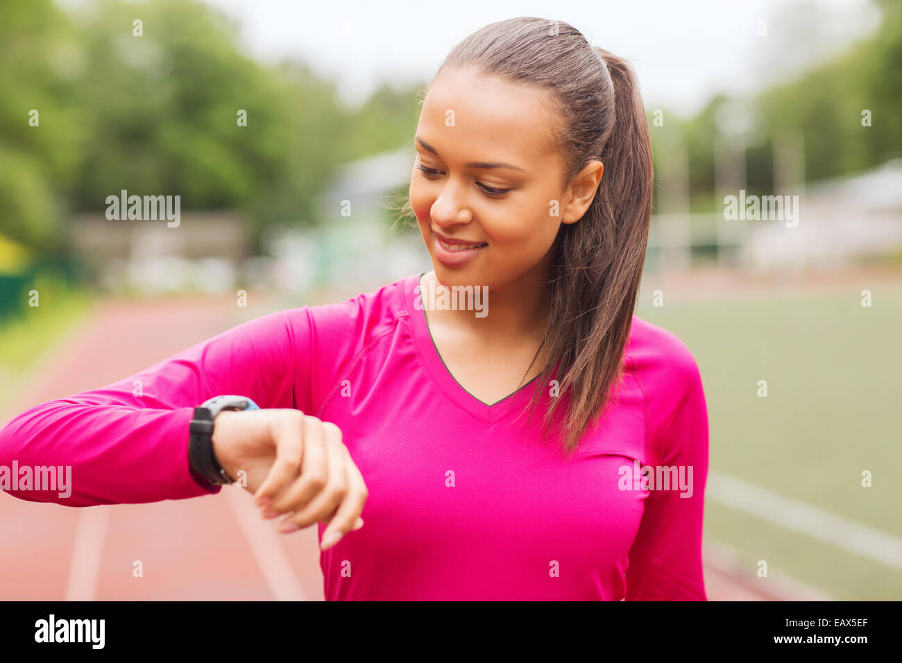 smiling woman running on track outdoors Stock Photo - Alamy