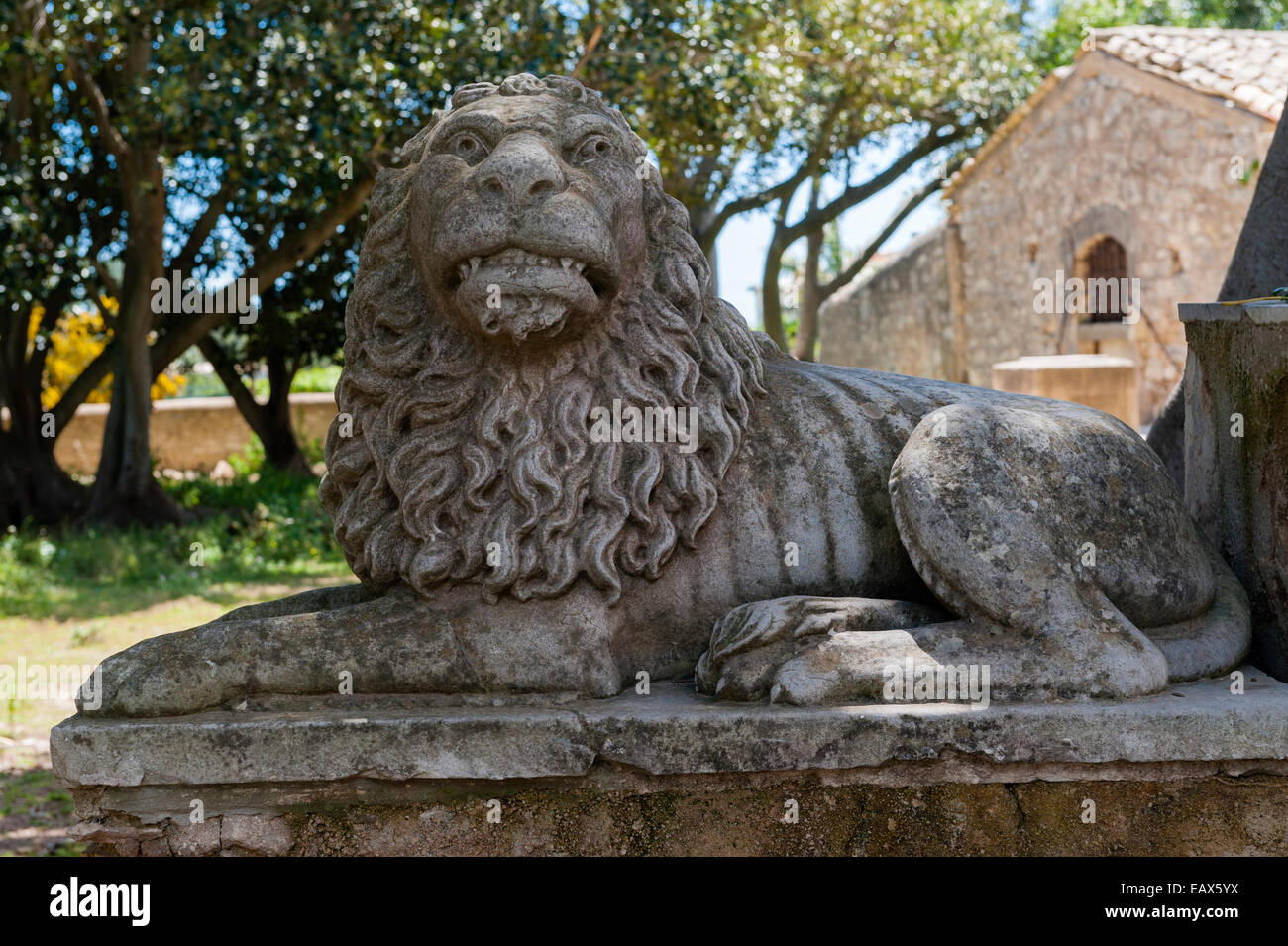 A carved stone lion guards the entrance to the 14c castle of ...
