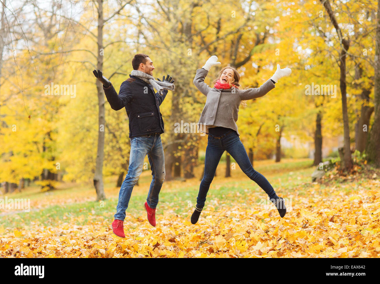 smiling couple having fun in autumn park Stock Photo - Alamy