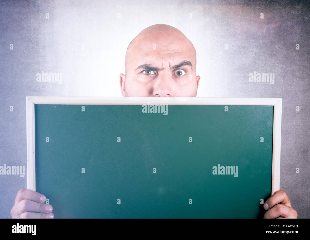 Bold man holding blank chalk board in his hands Stock Photo - Alamy