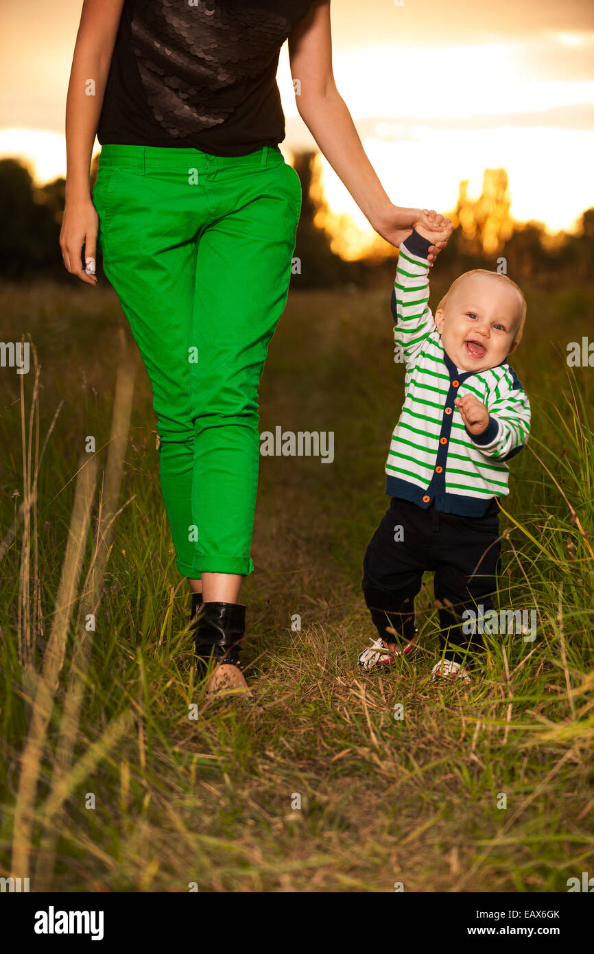 Adorable baby walking around with mother Stock Photo - Alamy