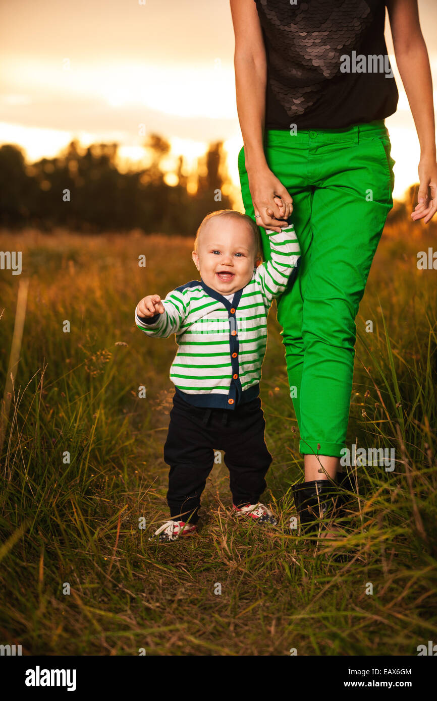 Adorable baby walking around with mother Stock Photo - Alamy