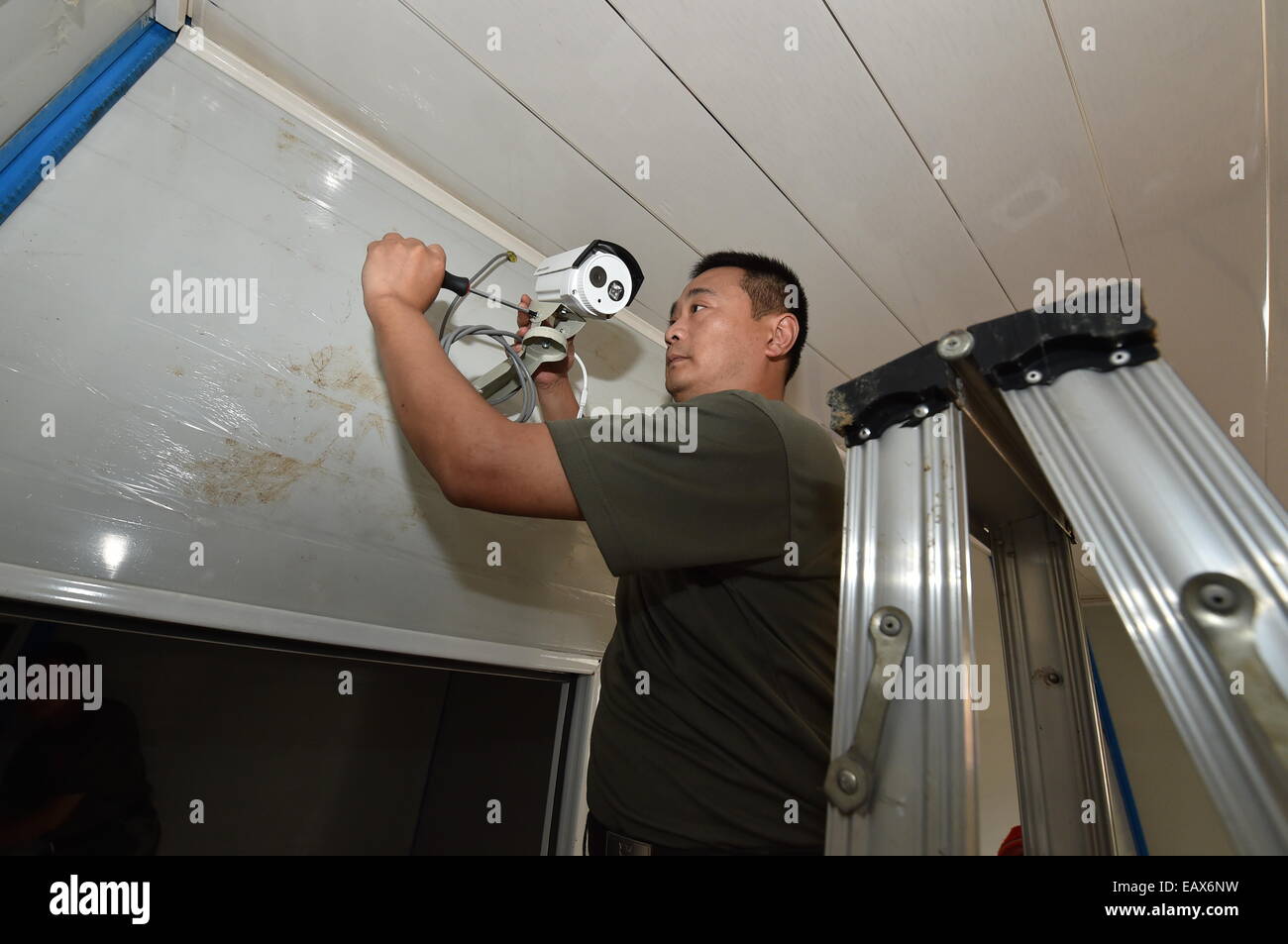Monrovia, Liberia. 20th Nov, 2014. A worker install a security camera ...