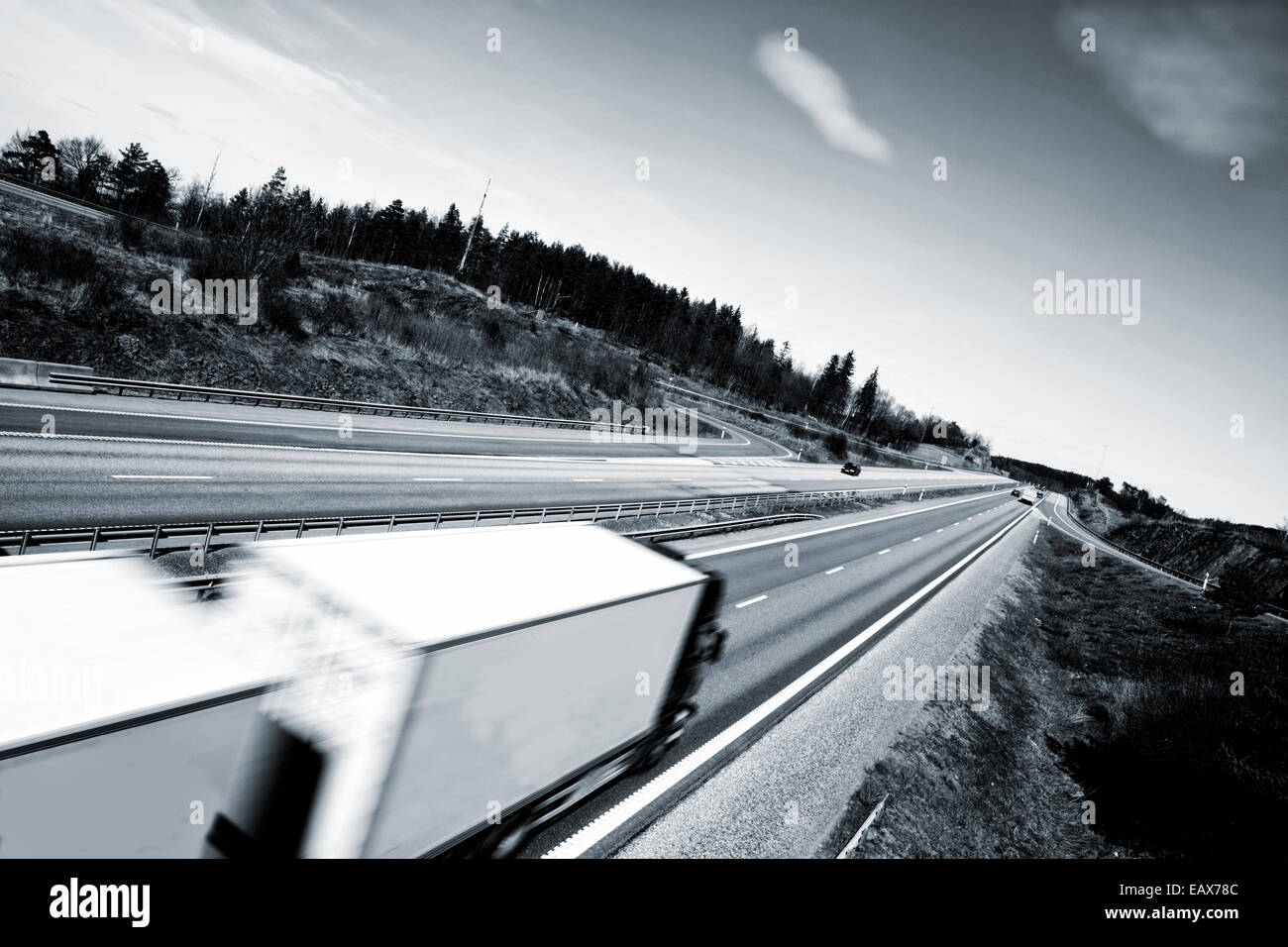large truck driving on long straight of freeway Stock Photo - Alamy
