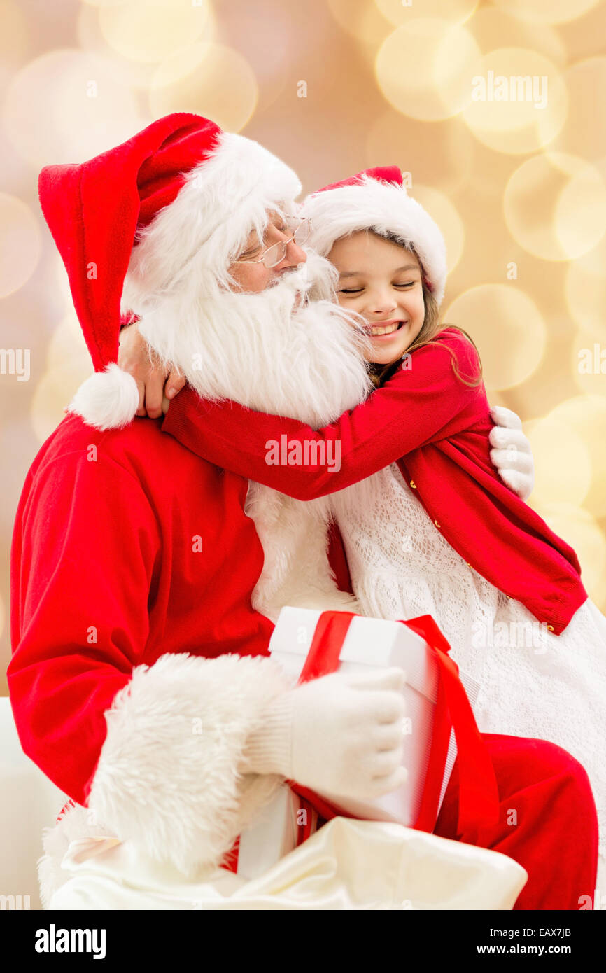 Teenage girl hugging santa hi-res stock photography and images - Alamy