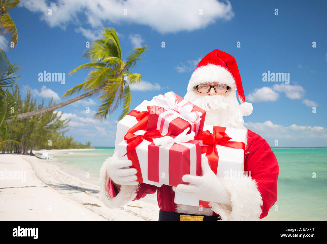 man in costume of santa claus with gift boxes Stock Photo - Alamy