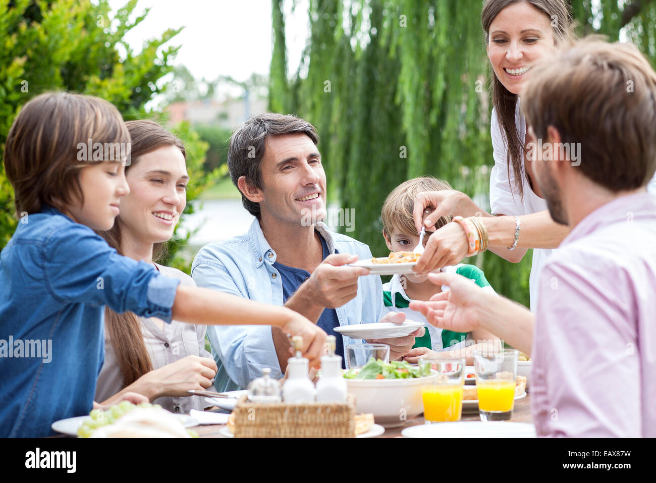 Family eating together at outdoor gathering Stock Photo - Alamy