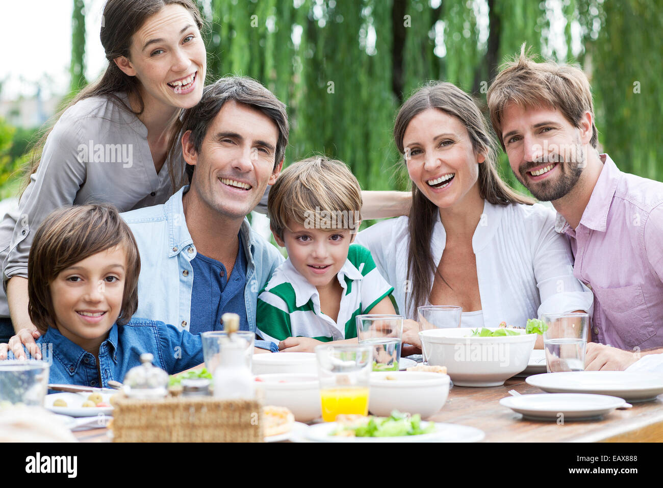 Family posing for portrait at outdoor gathering Stock Photo - Alamy