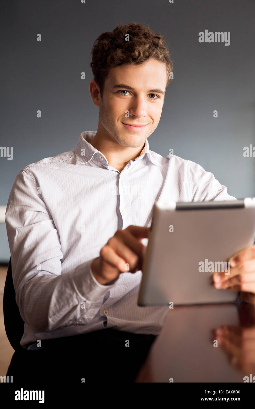 Businessman using digital tablet in office Stock Photo - Alamy