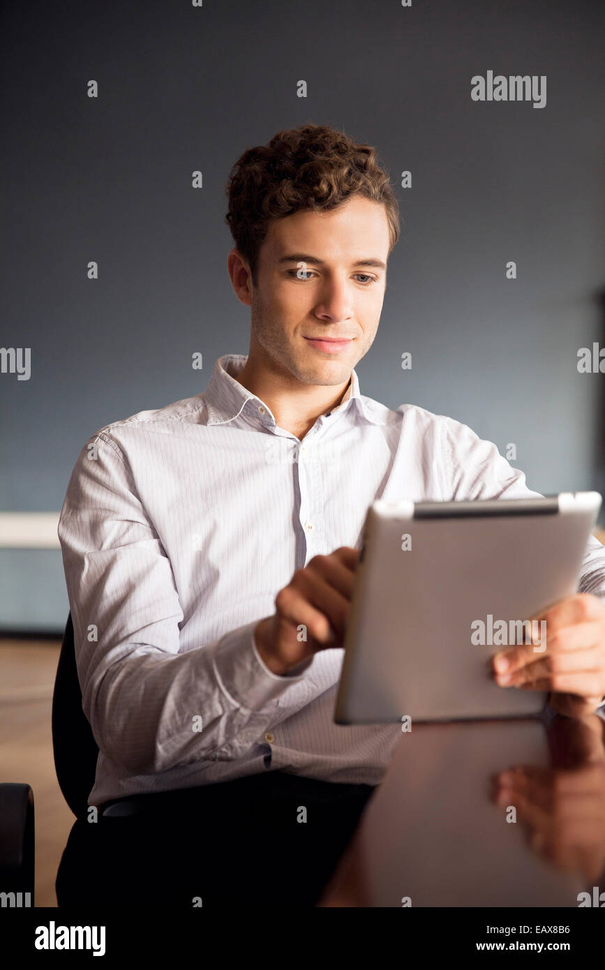 Businessman using digital tablet in office Stock Photo - Alamy