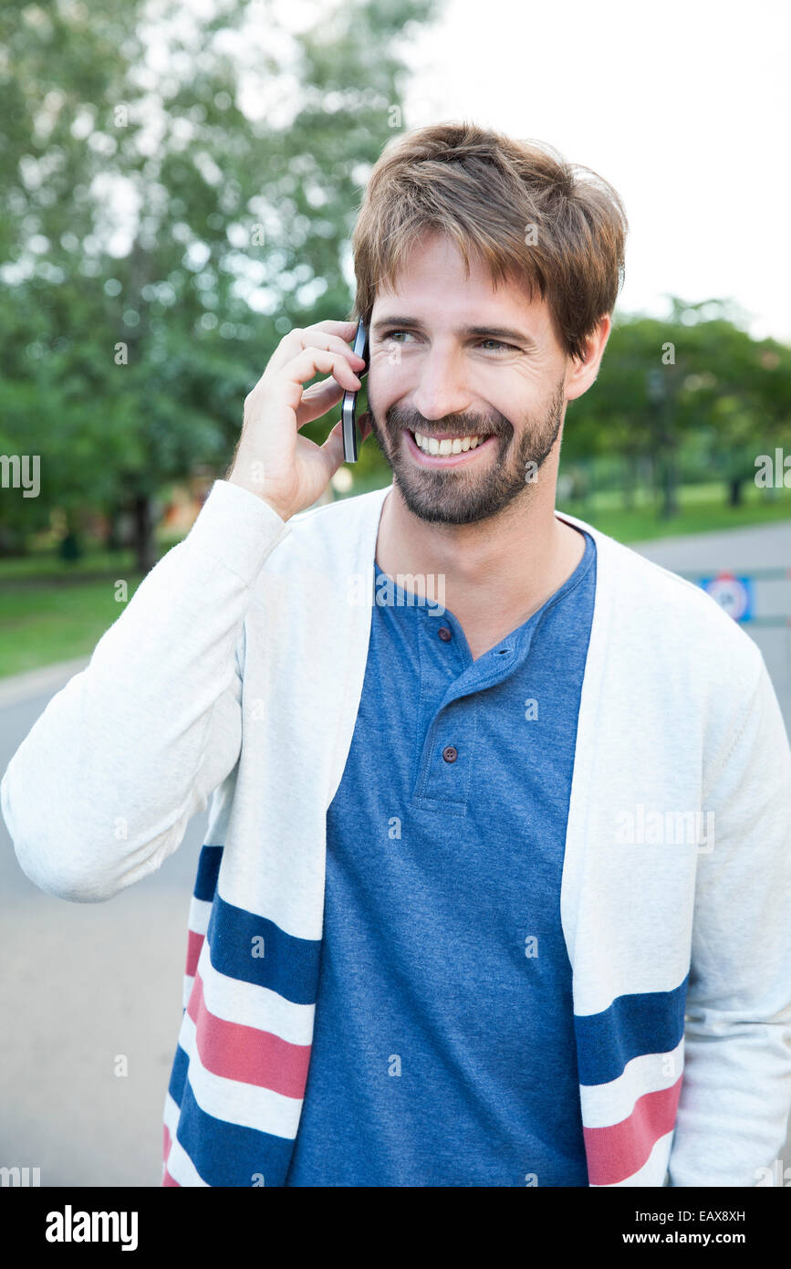 Man smiles using smartphone hi-res stock photography and images - Alamy