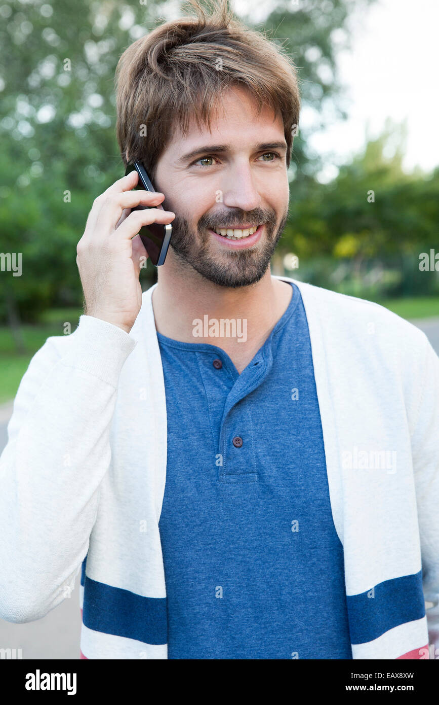 Man using smartphone outdoors Stock Photo - Alamy
