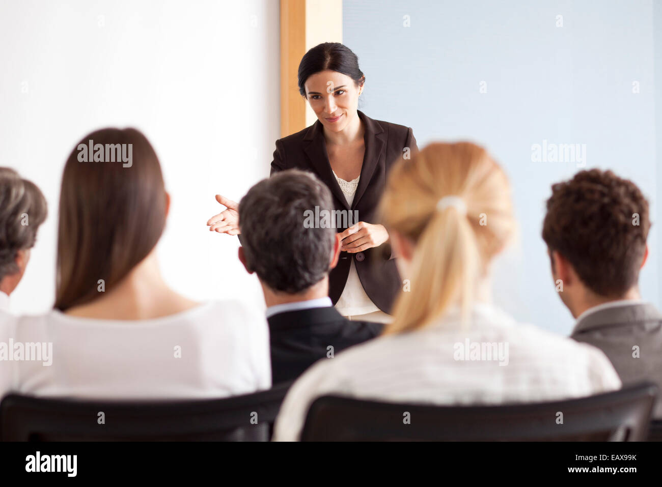 Businesswoman facilitating group discussion Stock Photo - Alamy