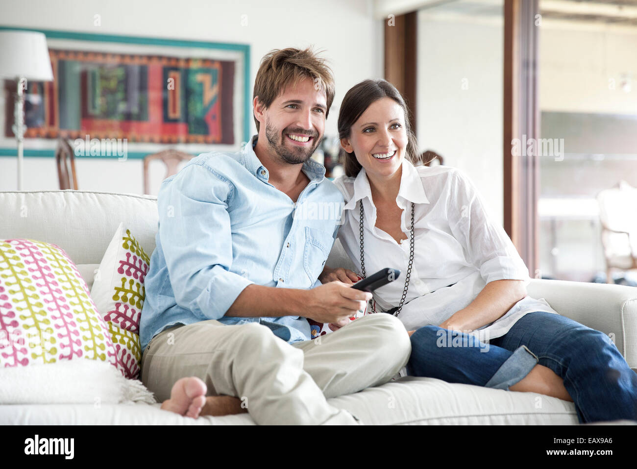 Couple watching TV together Stock Photo - Alamy