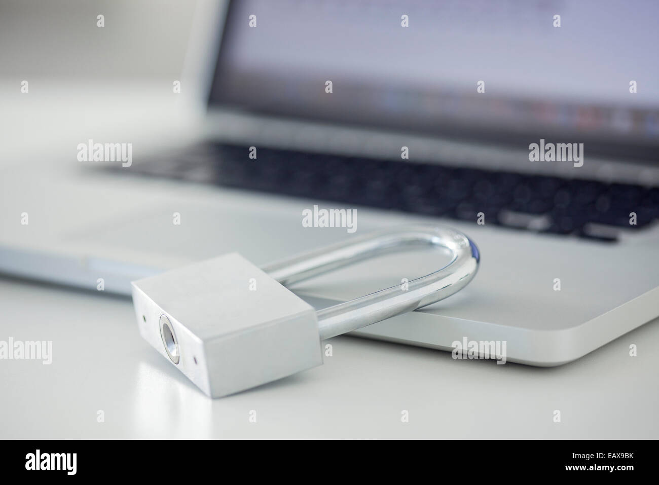 Padlock resting on laptop computer Stock Photo - Alamy