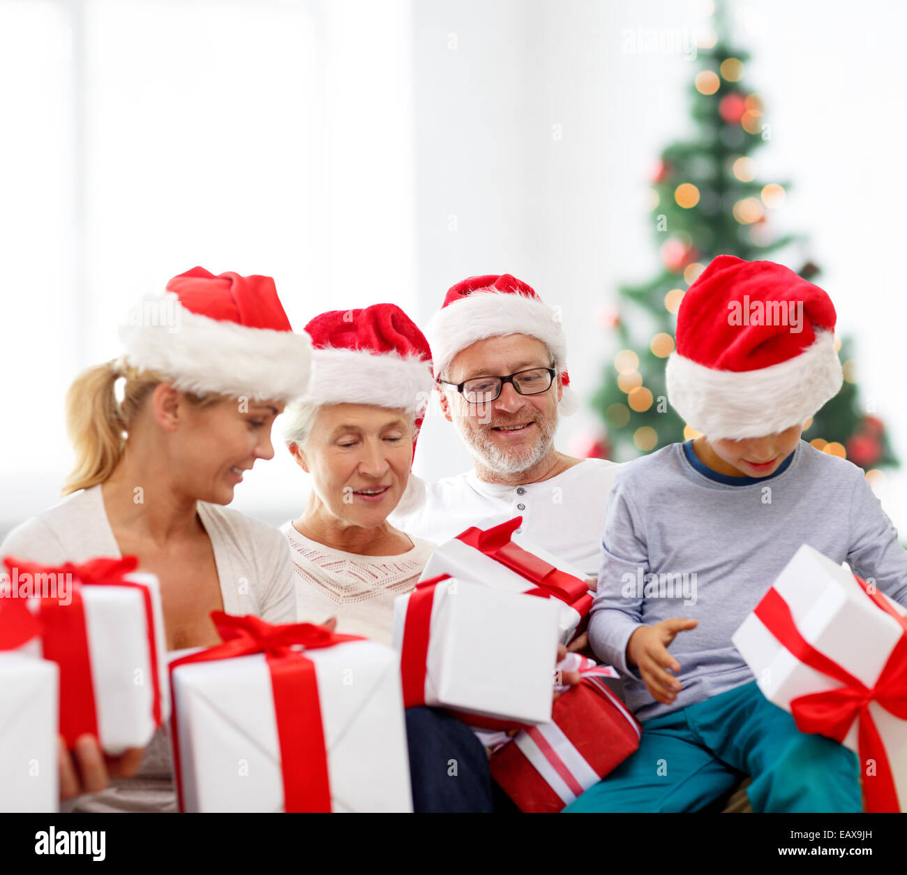 happy family in santa helper hats with gift boxes Stock Photo - Alamy