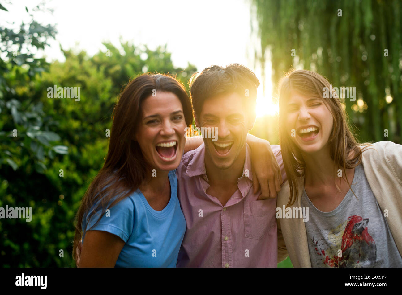 College friends having laughs together in park Stock Photo - Alamy
