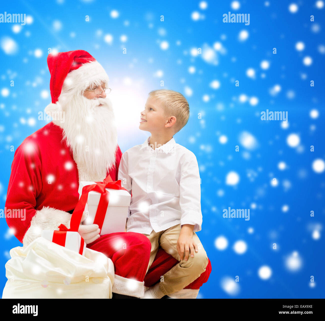 smiling little boy with santa claus and gifts Stock Photo - Alamy