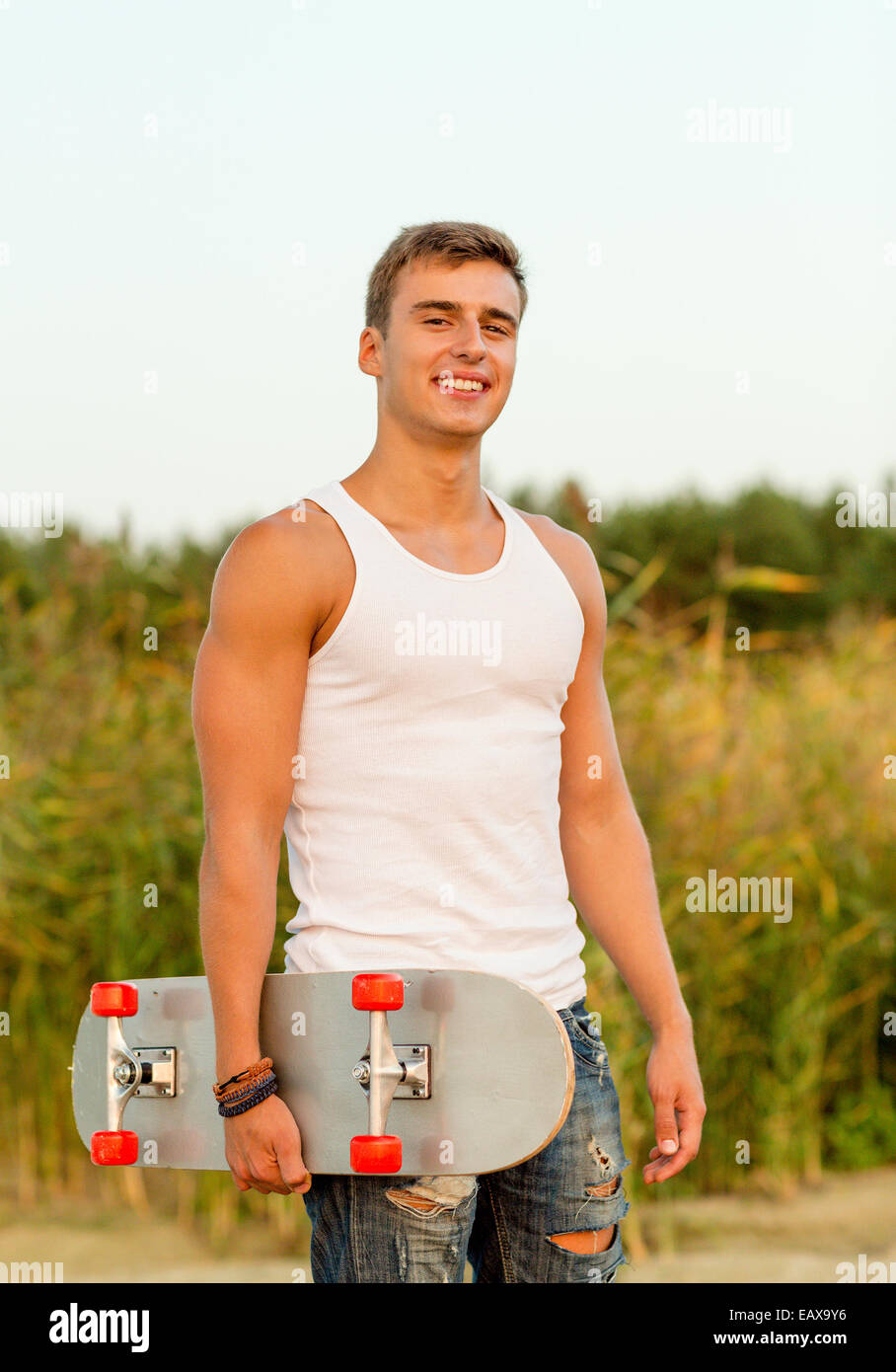 smiling teenage boy with skateboard outdoors Stock Photo - Alamy