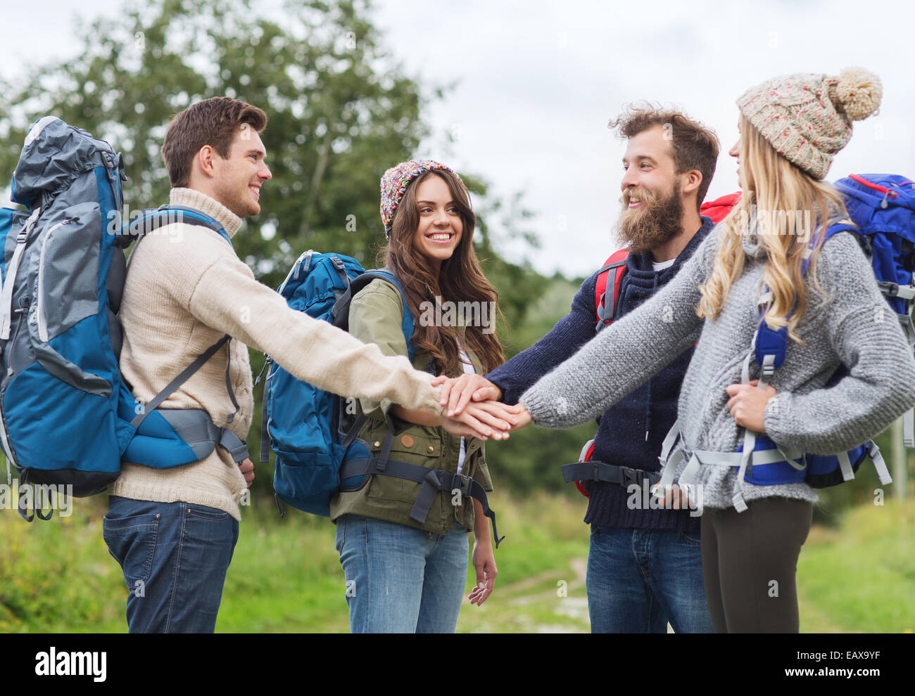 group of smiling friends with backpacks hiking Stock Photo - Alamy