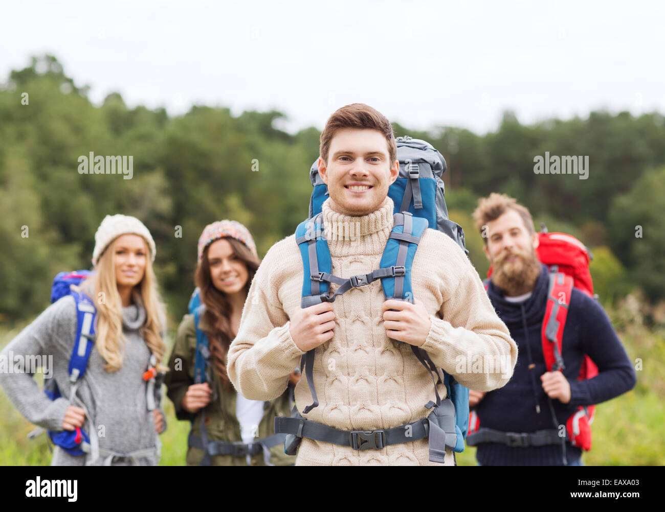 group of smiling friends with backpacks hiking Stock Photo - Alamy