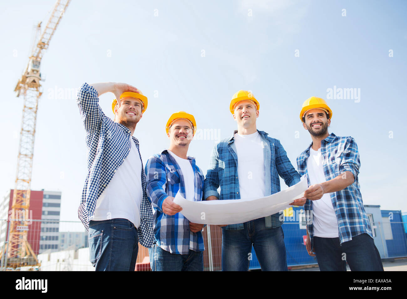 group of builders with tablet pc and blueprint Stock Photo - Alamy
