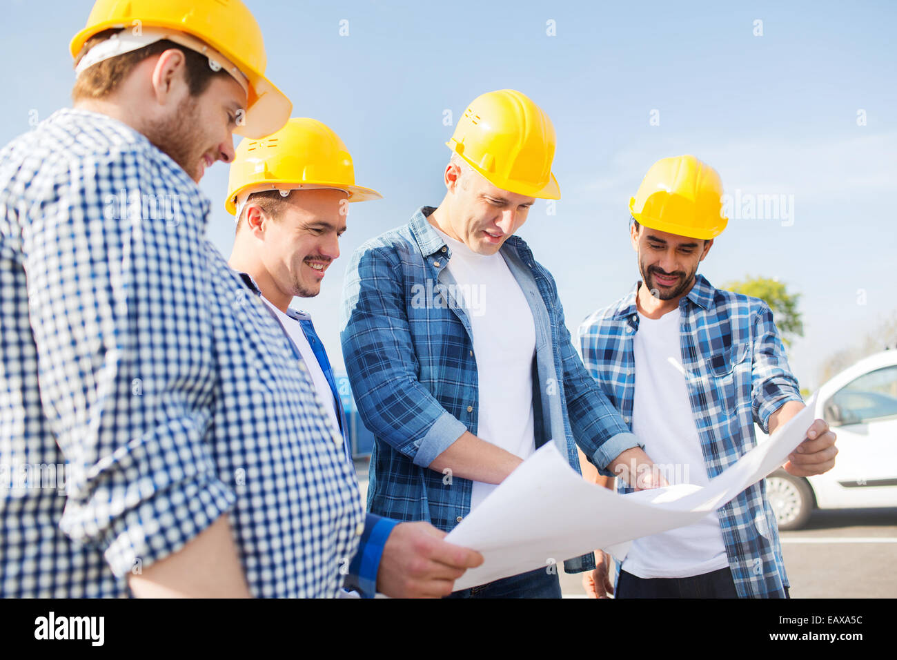 group of builders with tablet pc and blueprint Stock Photo - Alamy