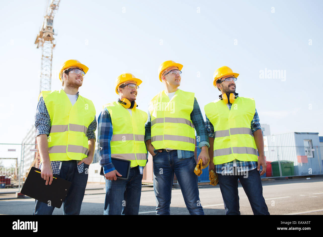 group of smiling builders with tablet pc outdoors Stock Photo - Alamy