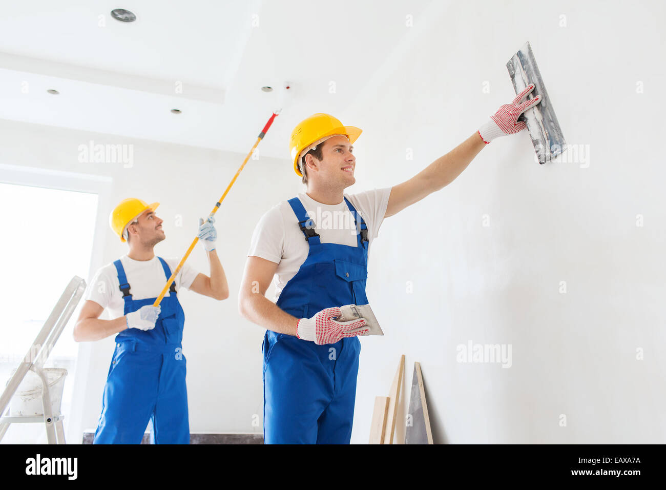 group of builders with tools indoors Stock Photo - Alamy