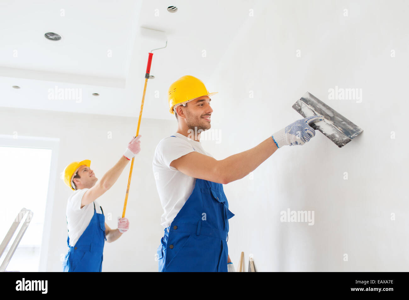 group of builders with tools indoors Stock Photo - Alamy
